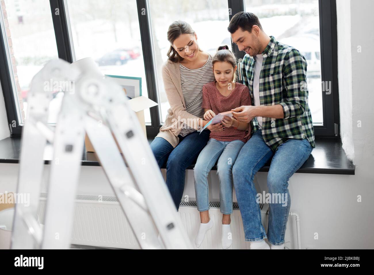 happy family with color palette moving to new home Stock Photo - Alamy