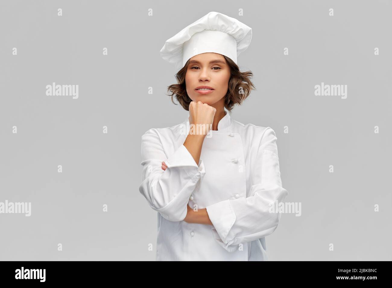 female chef in toque thinking Stock Photo - Alamy