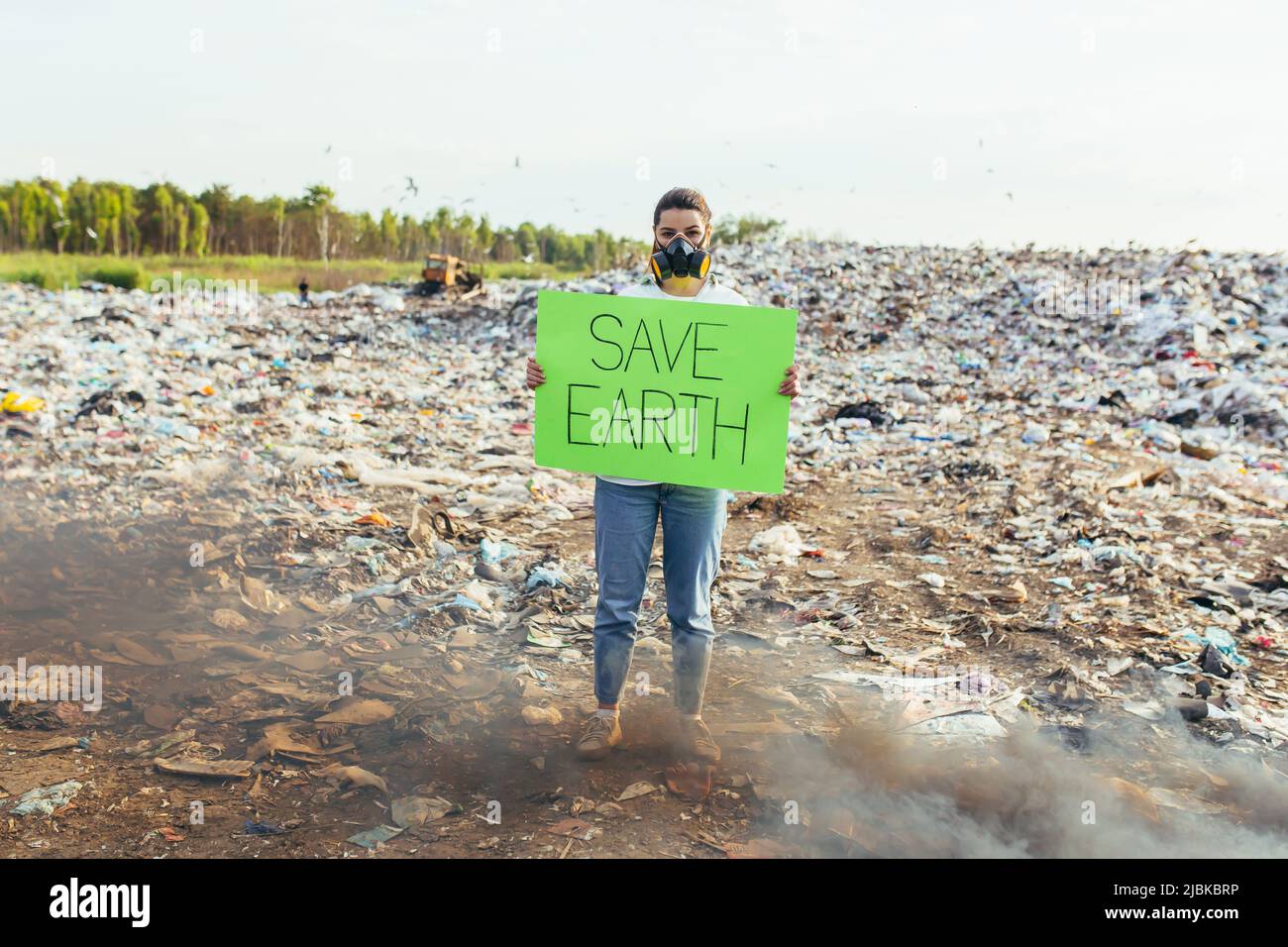 Woman with a poster save the planet, pickets garbage-contaminated ...