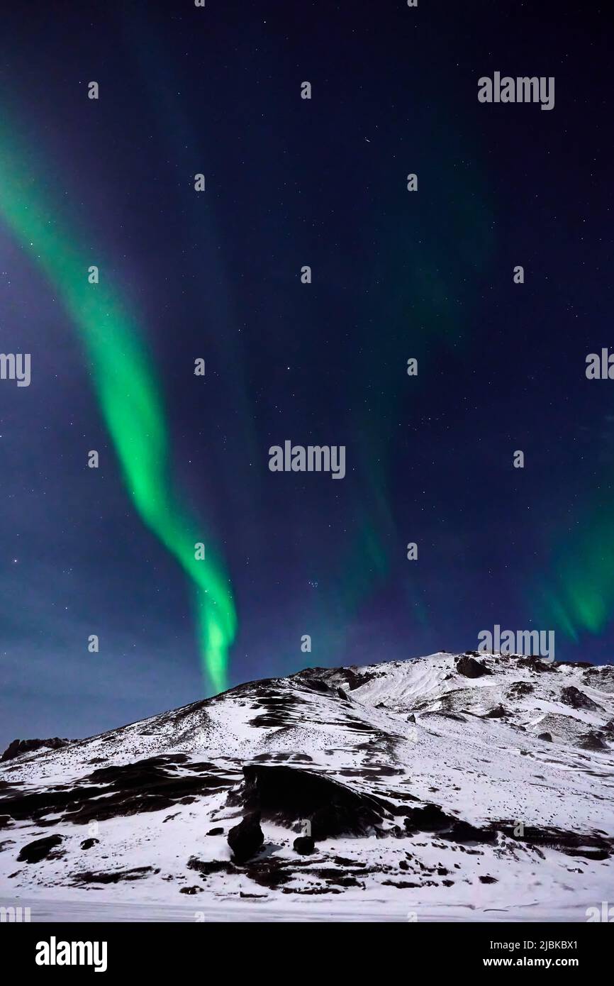 Northern lights aurora borealis over snowy mountains hi-res stock ...