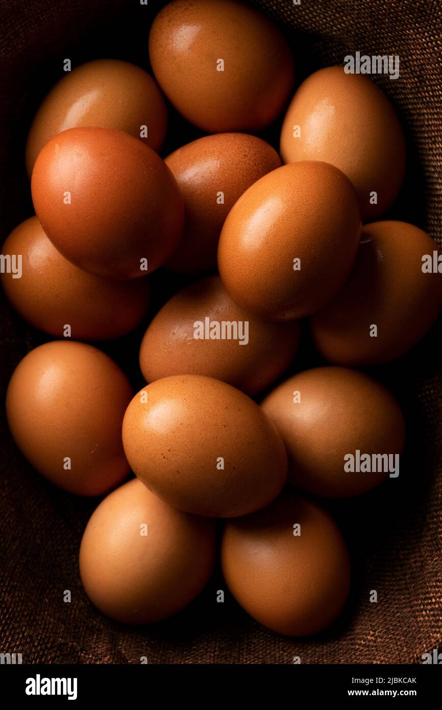 Red hen eggs on dark rustic table, organic food ingredients Stock Photo ...