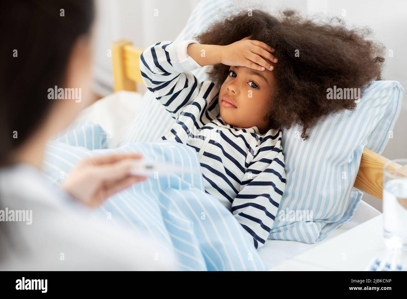 doctor measuring sick girl's temperature Stock Photo - Alamy