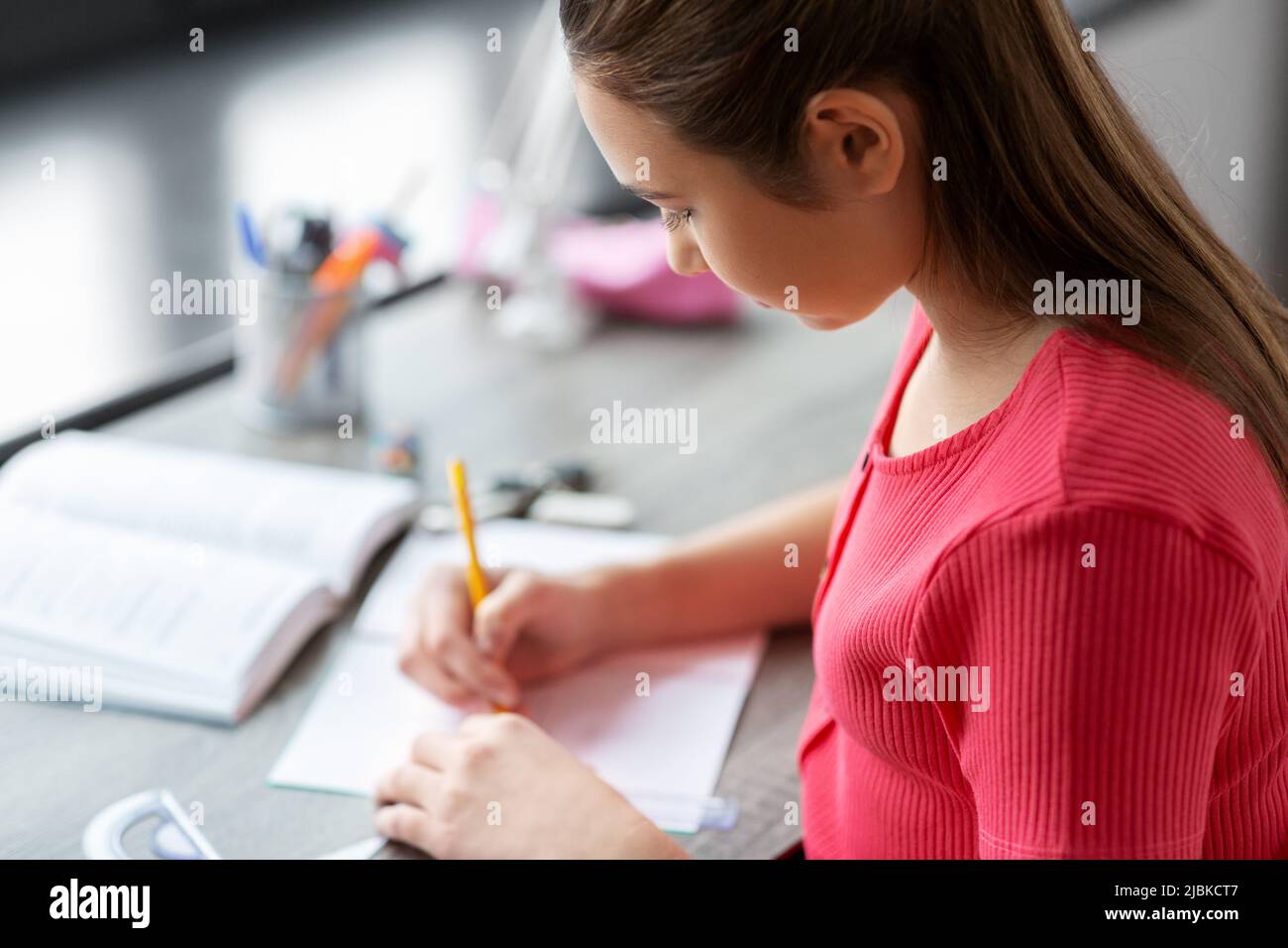 student girl with ruler drawing line in notebook Stock Photo - Alamy