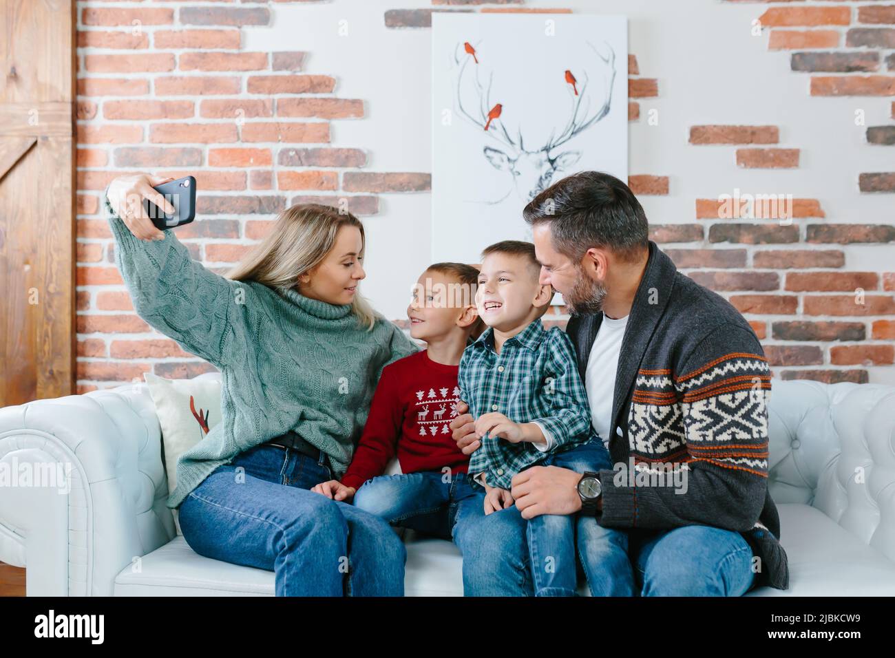 Young family having fun talking on a video call using a mobile phone ...