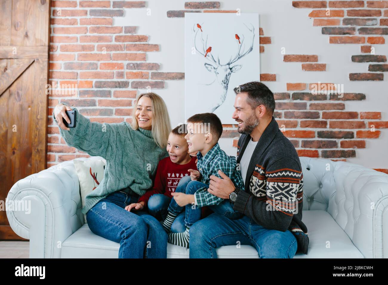Young family having fun talking on a video call using a mobile phone ...