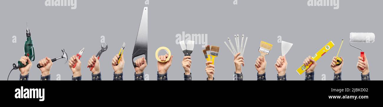 builder's hands holding different working tools Stock Photo - Alamy