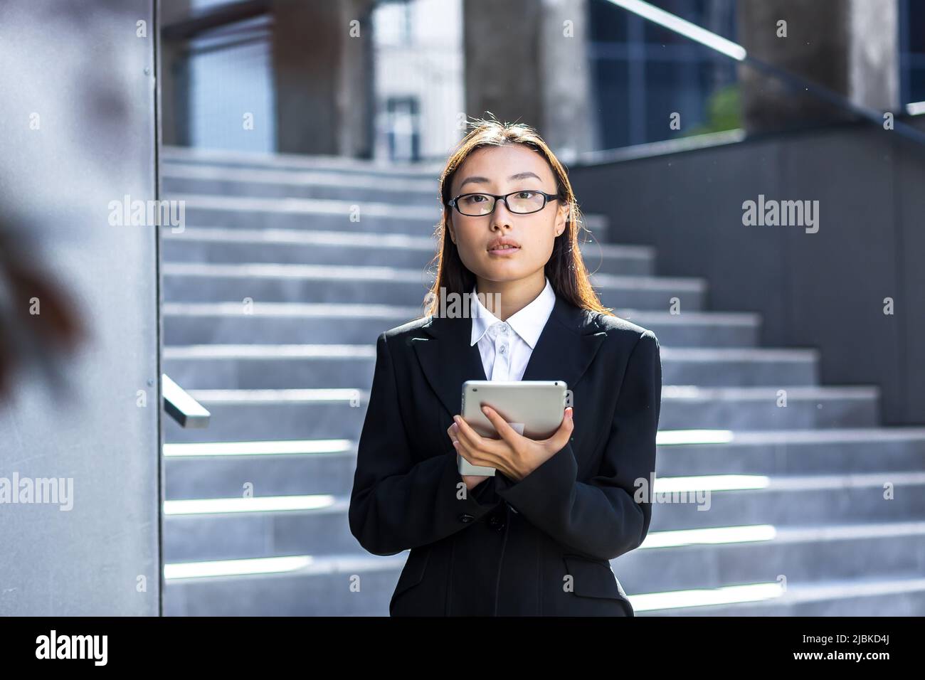vertical frame, portrait of asian female teacher with glasses looking ...