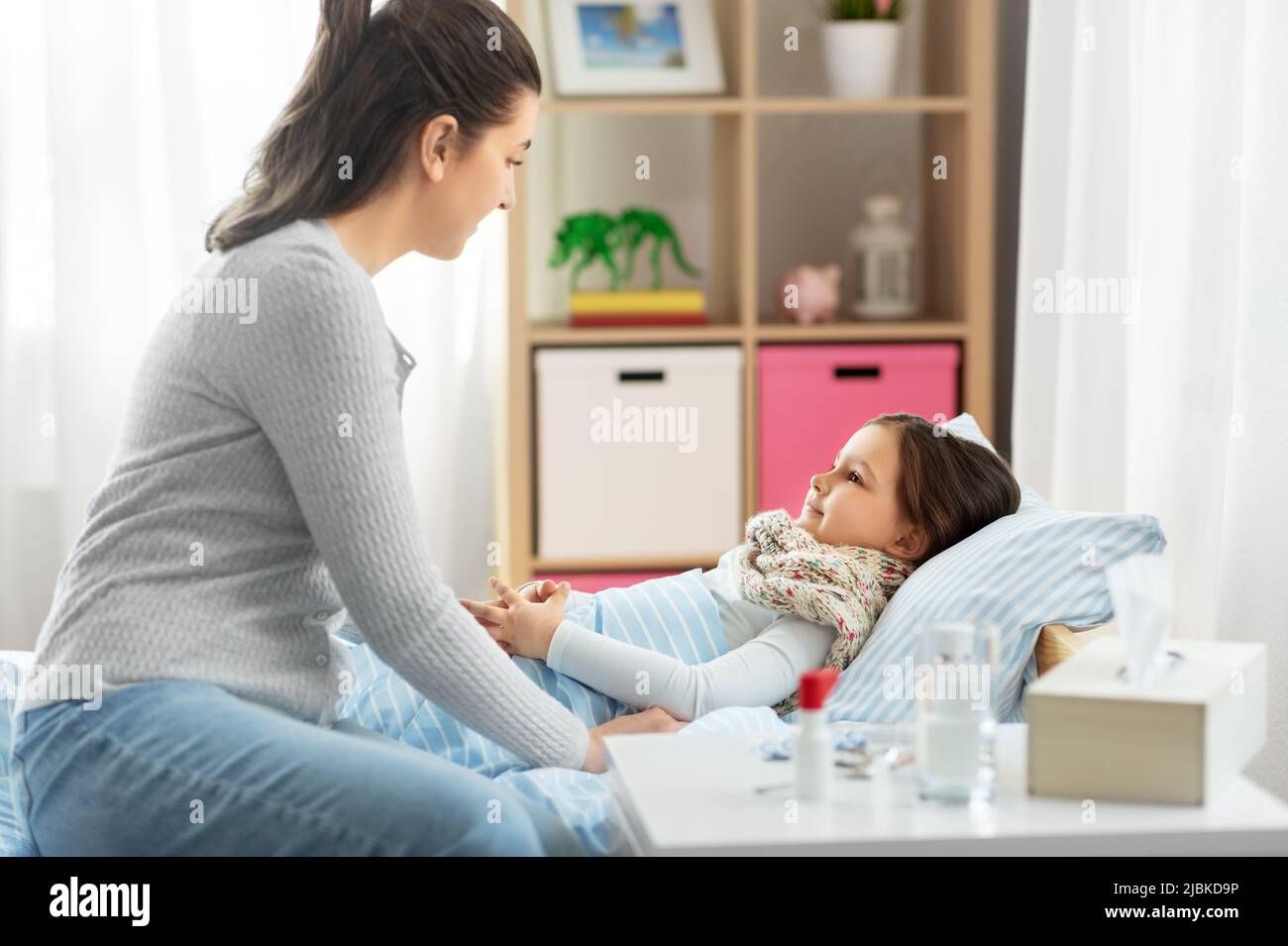 mother and sick little daughter in bed at home Stock Photo - Alamy