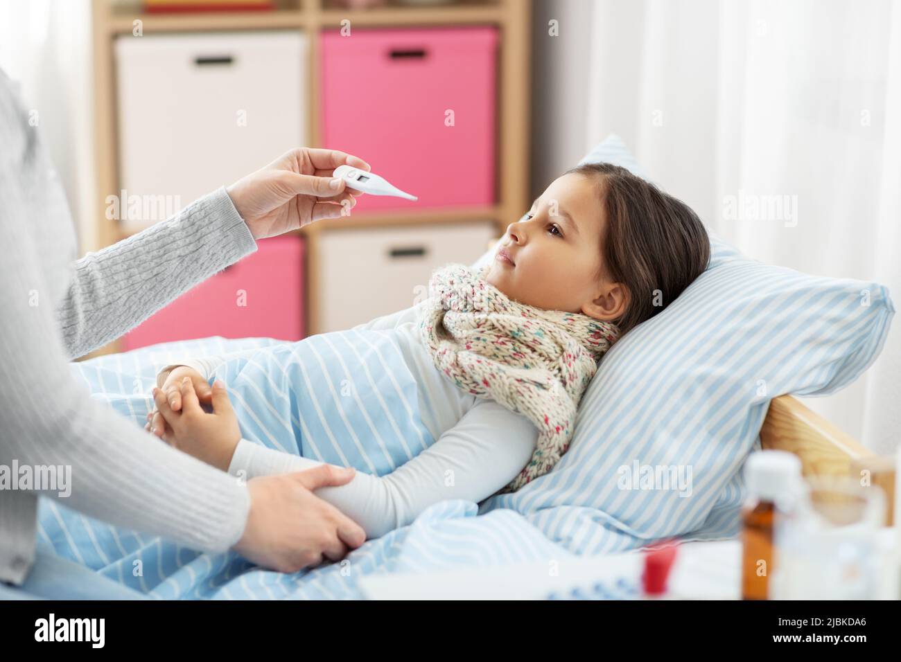 mother measuring temperature of sick daughter Stock Photo - Alamy