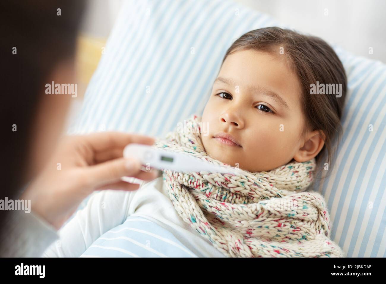 mother measuring temperature of sick daughter Stock Photo - Alamy