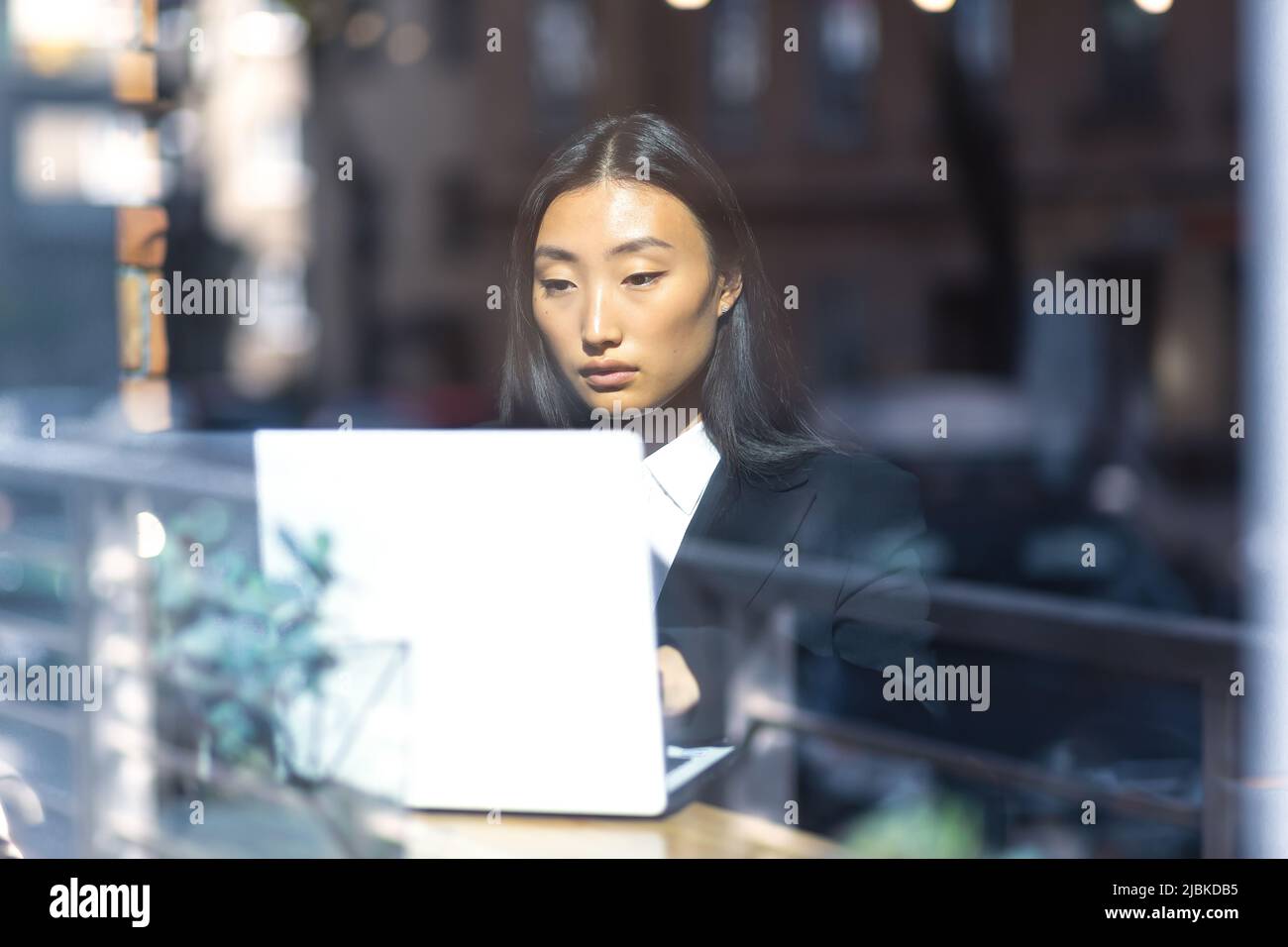 Beautiful female student working at computers, Asian woman in cafe look ...