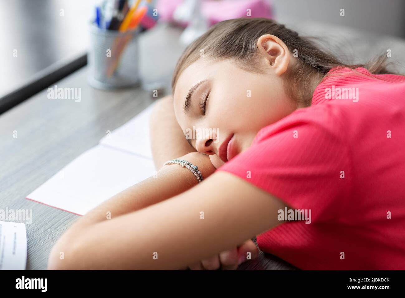 tired student girl sleeping on table at home Stock Photo - Alamy