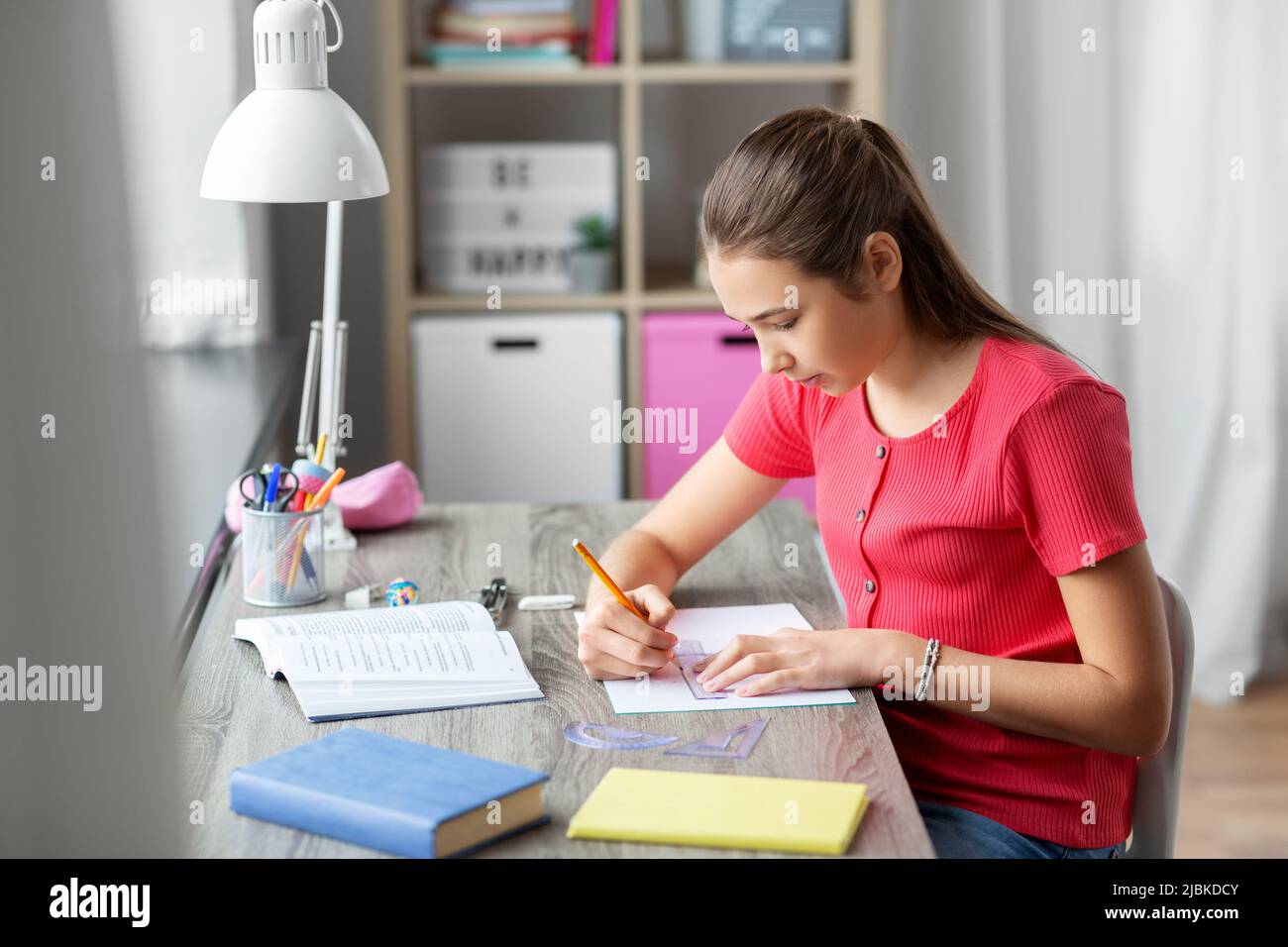 student girl with ruler drawing line in notebook Stock Photo - Alamy