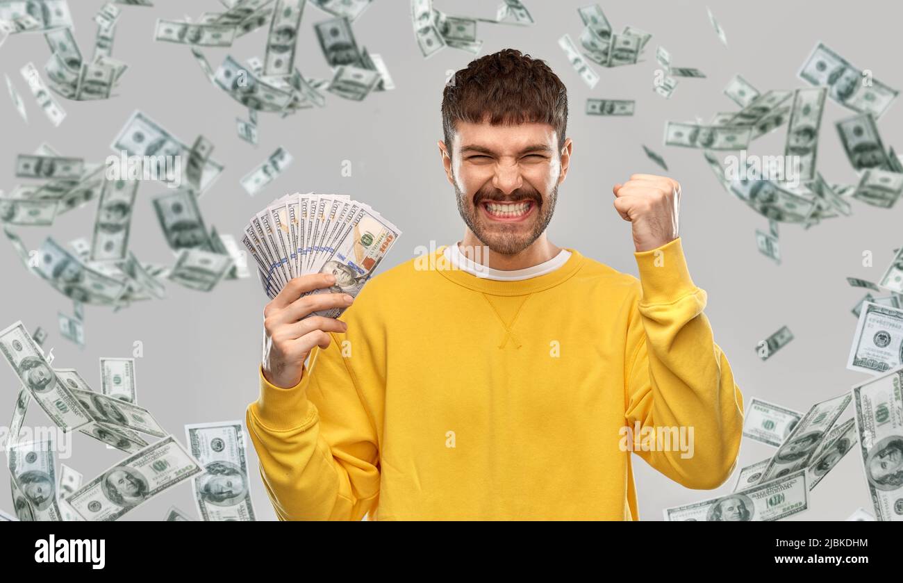 happy young man with money celebrating success Stock Photo - Alamy