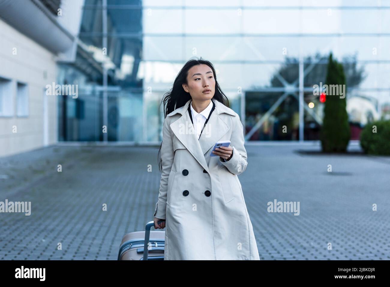 Beautiful female tourist near the airport, a Chinese woman walking with ...