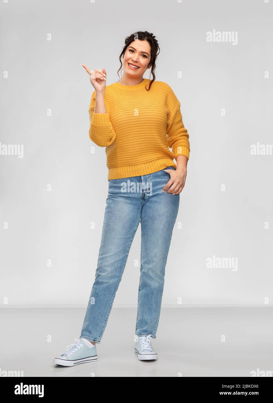 happy smiling young woman pointing finger up Stock Photo - Alamy happy smiling young woman pointing finger up Stock Photo - Alamy