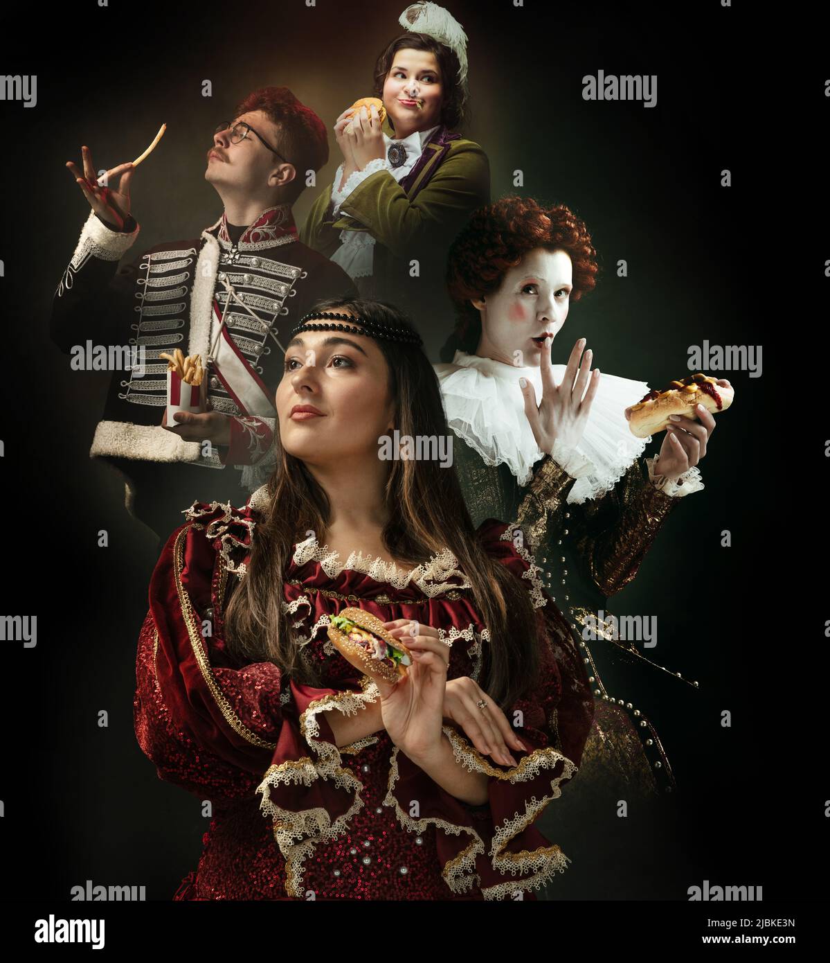 Medieval people as a royalty persons in vintage clothing eating fast ...