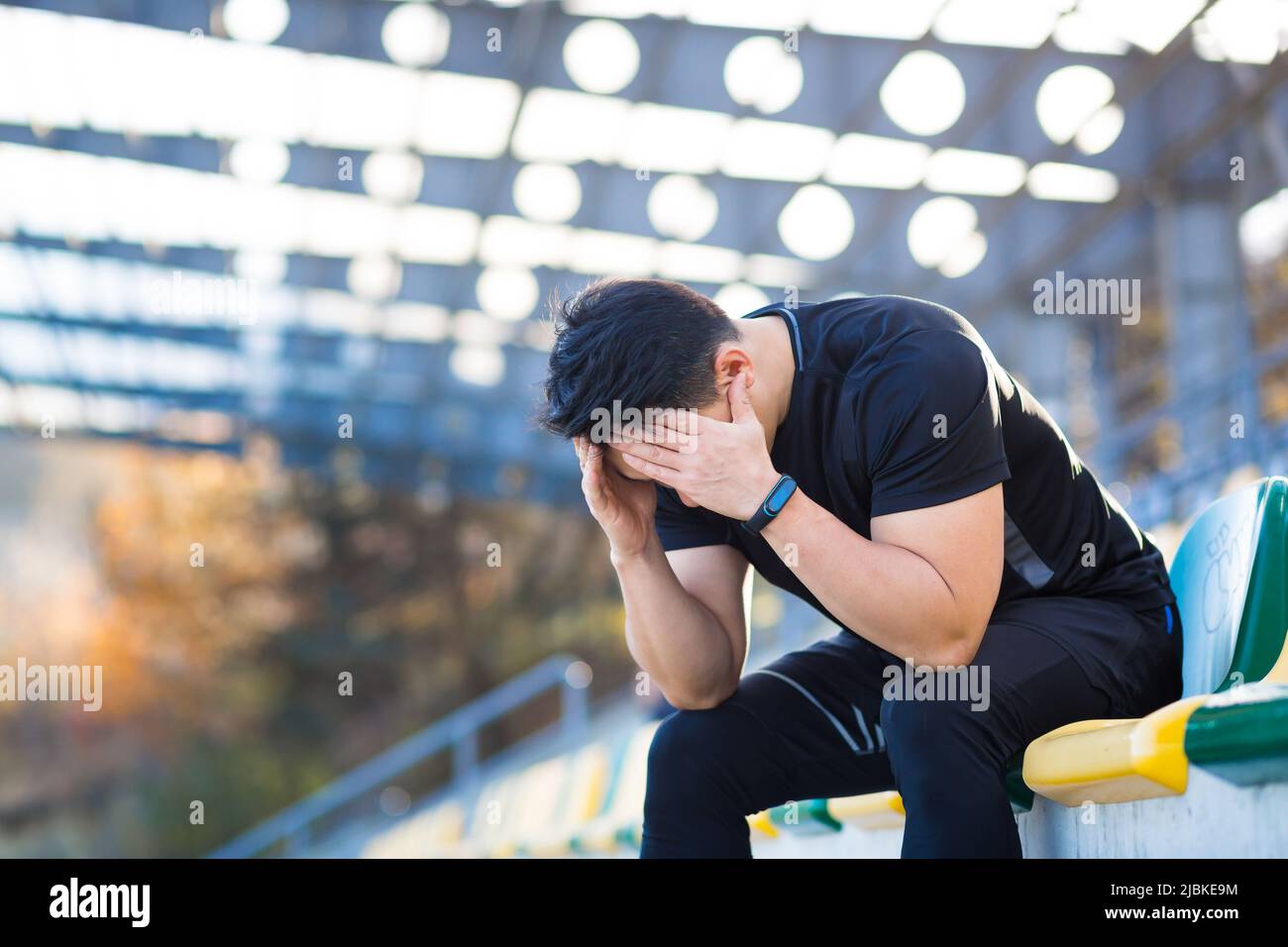 Frustrated Asian male athlete depressed, dissatisfied with the result ...