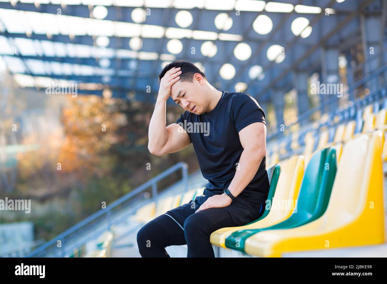 Frustrated Asian male athlete depressed, dissatisfied with the result ...