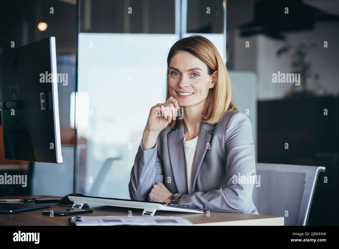 Happy and successful business woman boss working at computer in modern ...