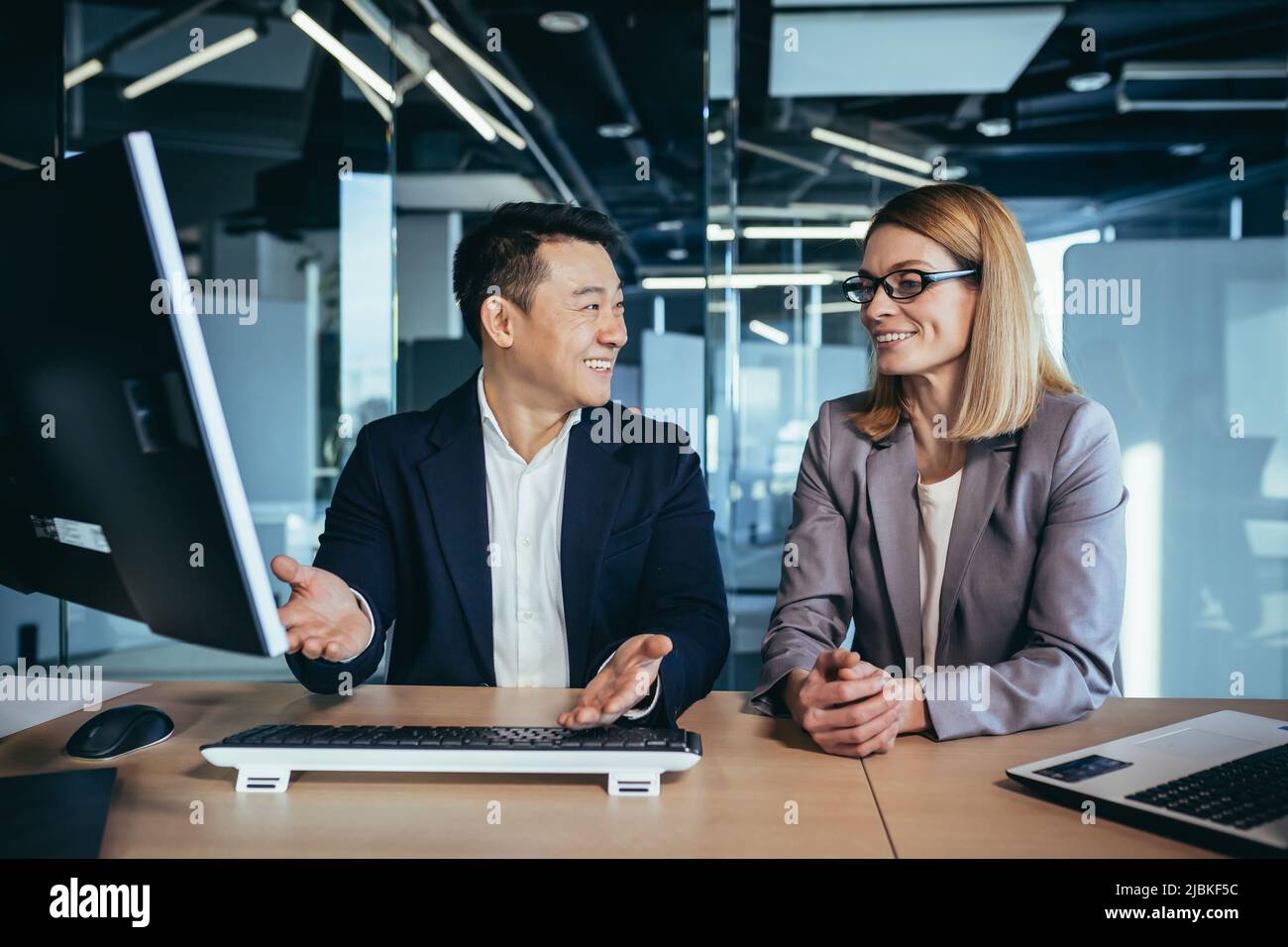 Friendly conversation of colleagues at work in the office. Asian man ...