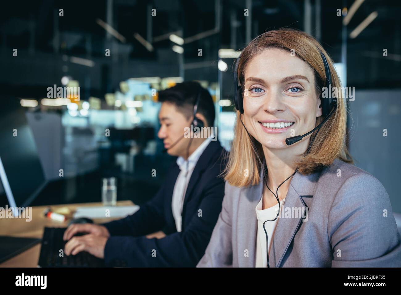 call center employee provide help to client distantly. Asian male customer services agent with ...