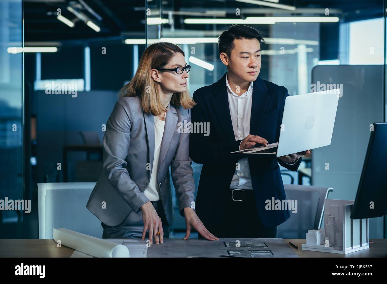 A team of multiracial business architects and designers discuss ...