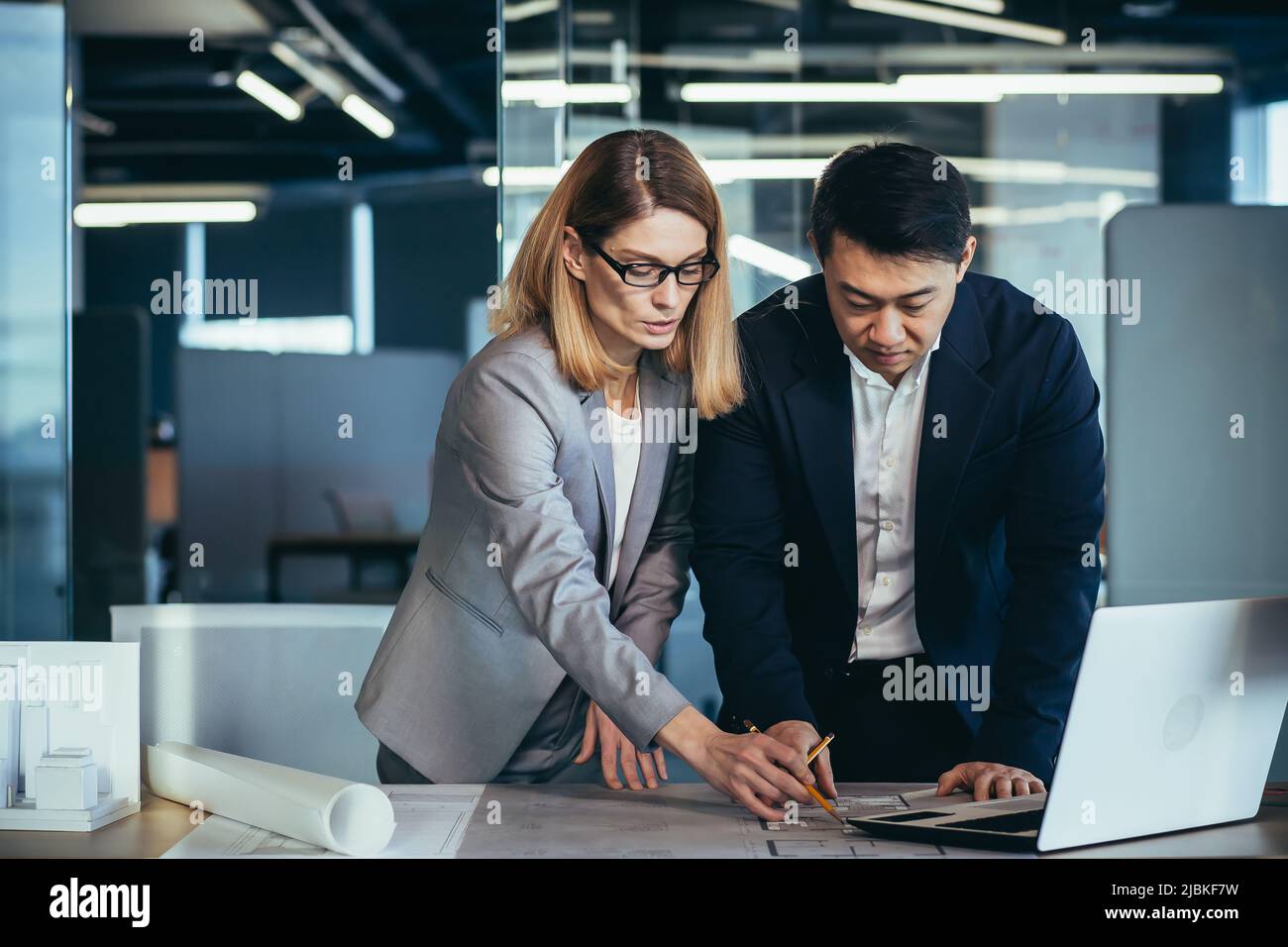 A team of multiracial business architects and designers discuss ...