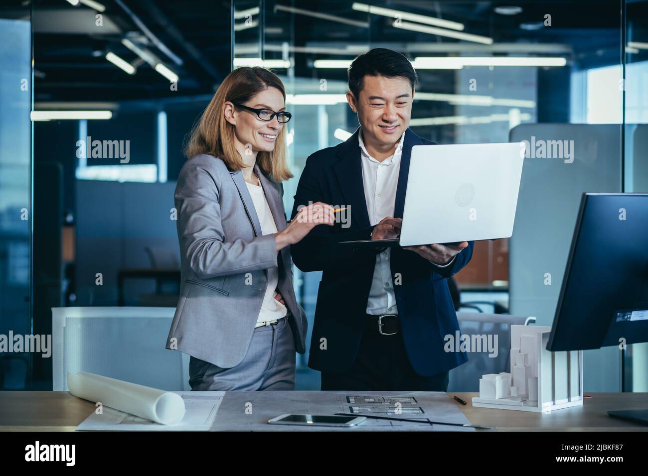 A team of multiracial business architects and designers discuss ...