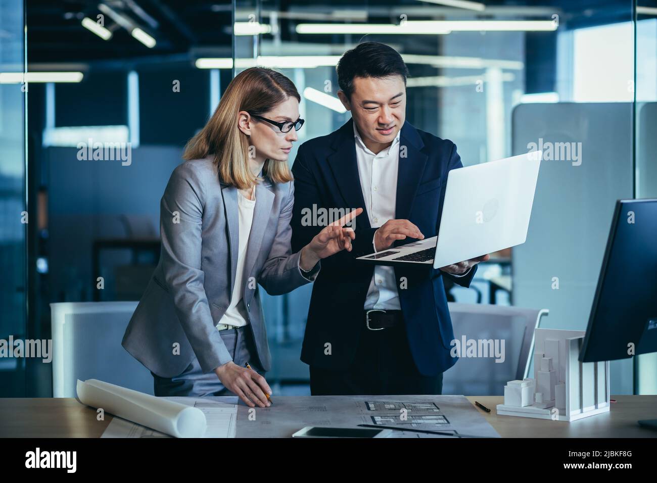 A team of multiracial business architects and designers discuss ...