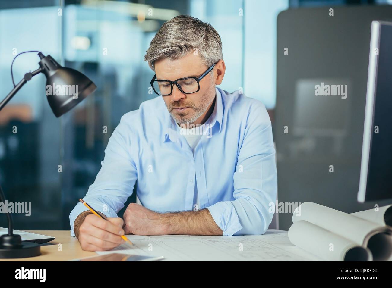 Experienced architect designer head working on projector portrait close ...