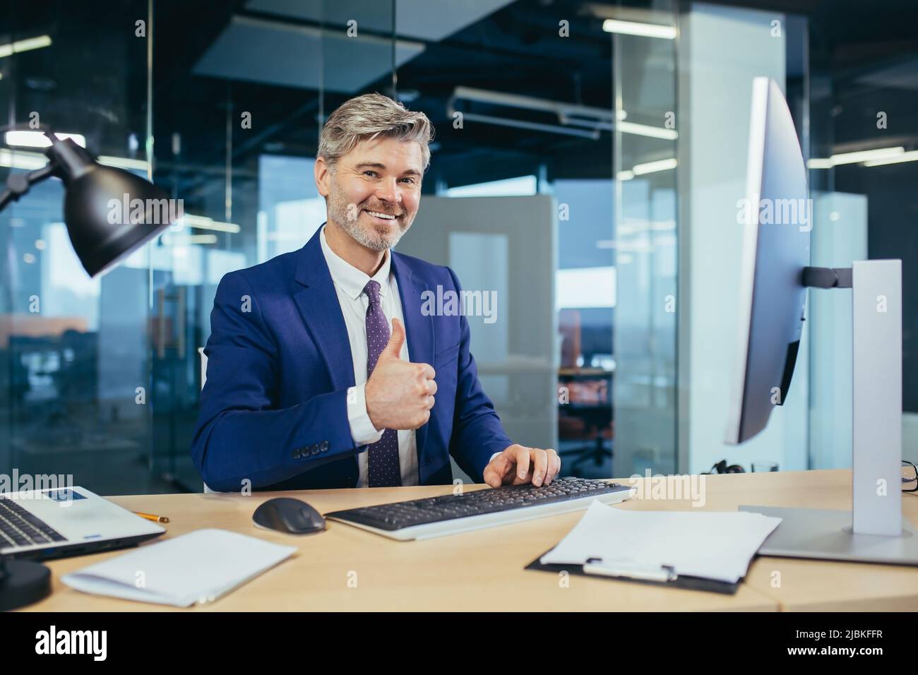 Portrait of a successful experienced gray-haired broker man, business ...