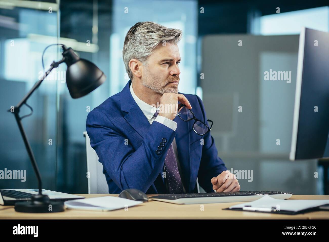 Portrait of a man, businessman thinking while working in the office at ...