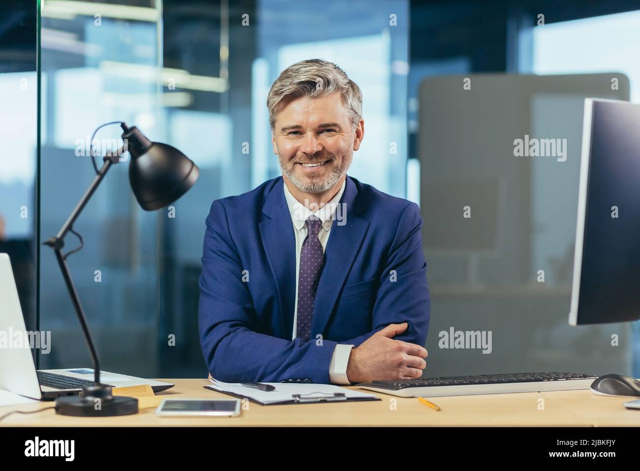 Portrait of a successful experienced gray-haired broker man, business ...