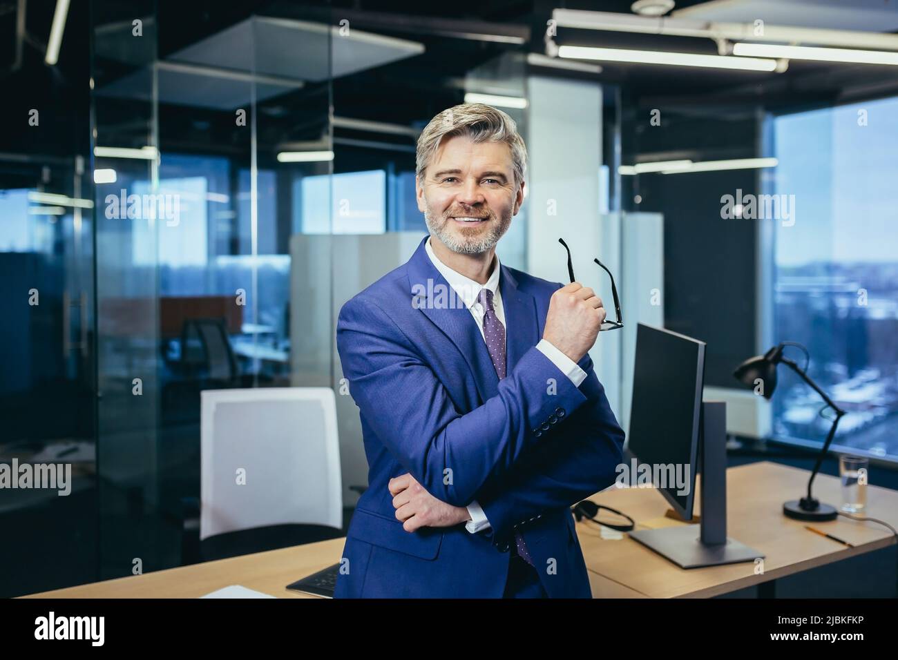 Portrait of successful gray-haired businessman, man with working in ...