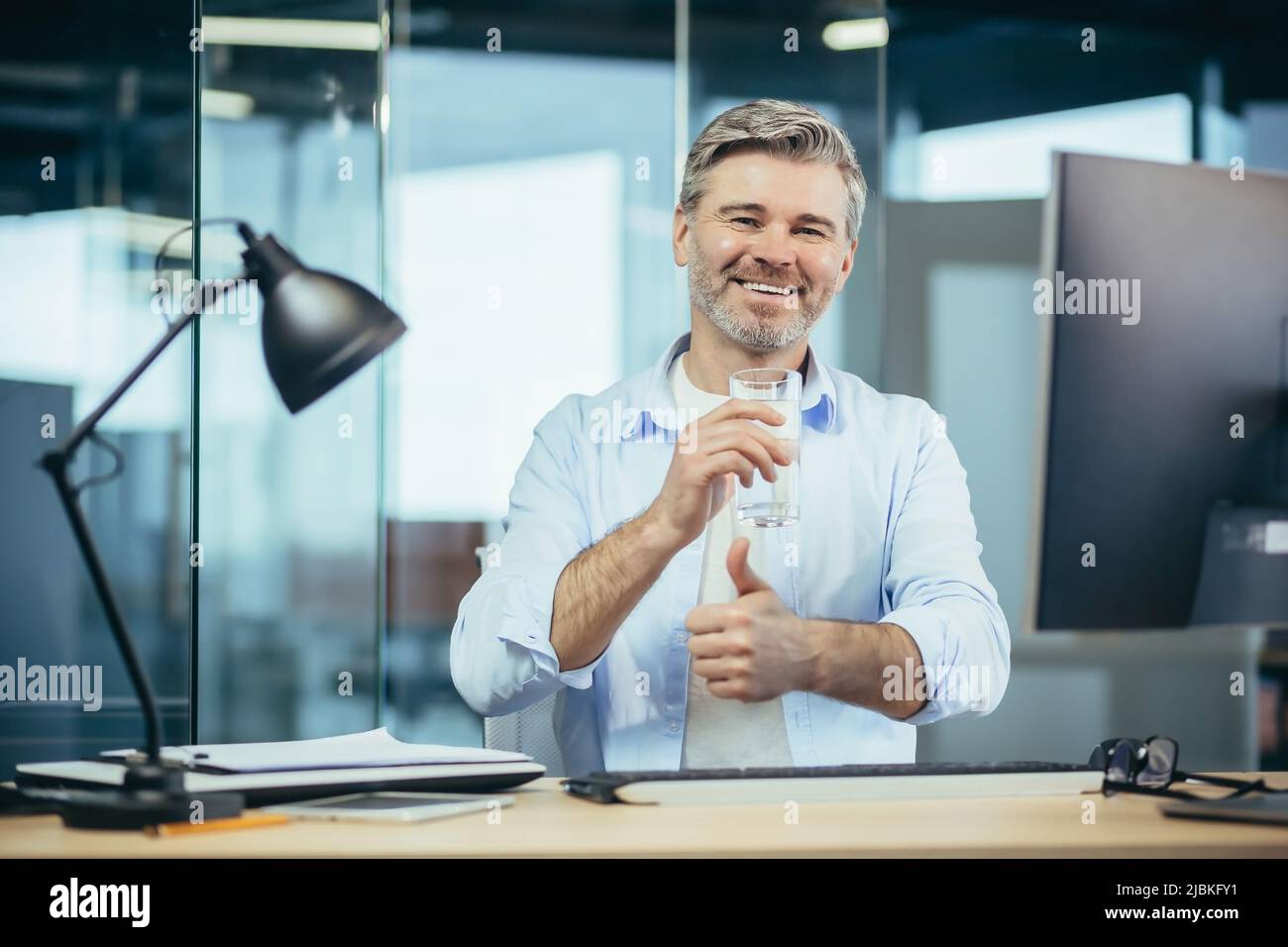 Successful worker businessman boss, looking at camera and smiling ...