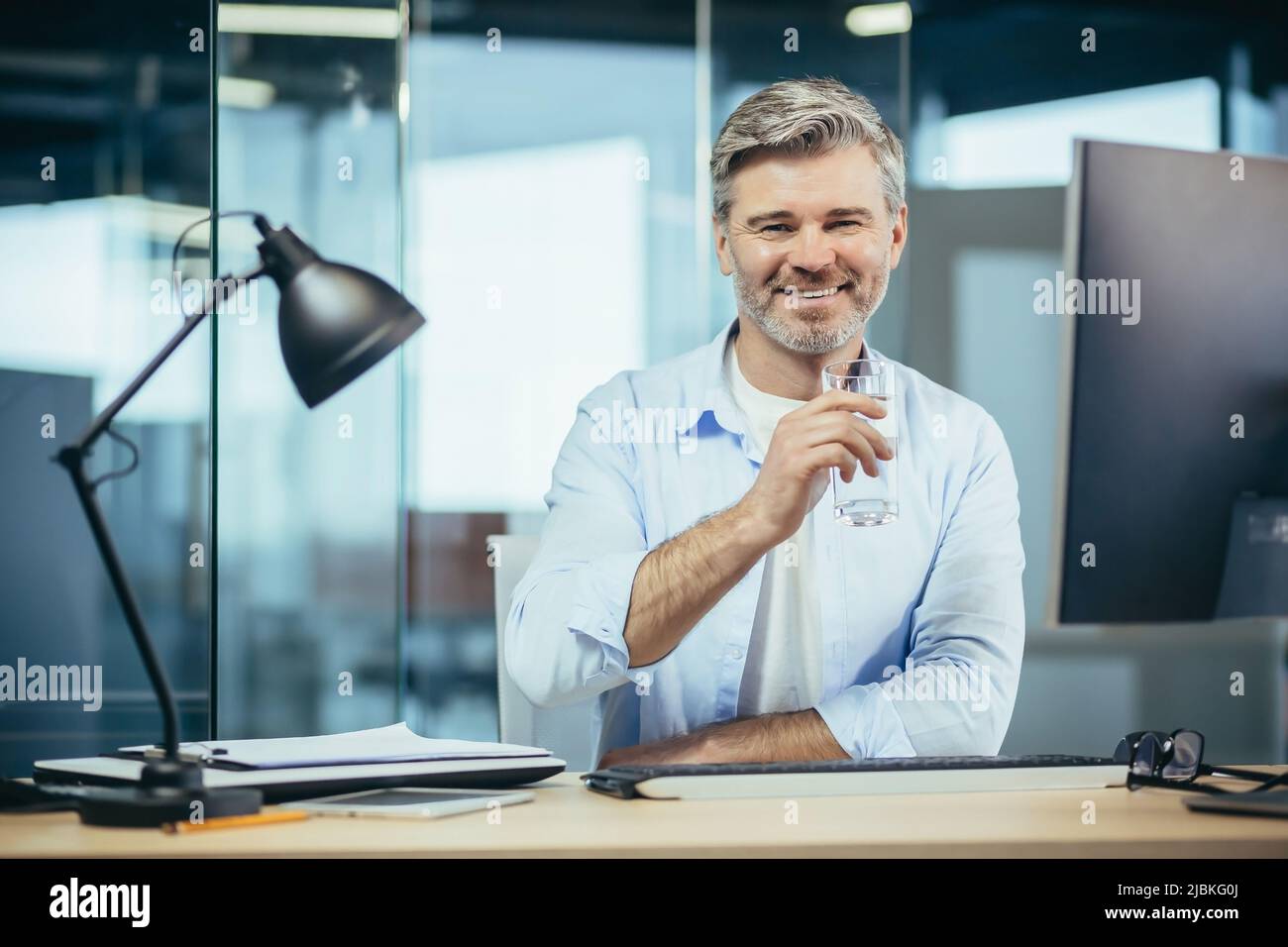 Successful worker businessman boss, looking at camera and smiling ...
