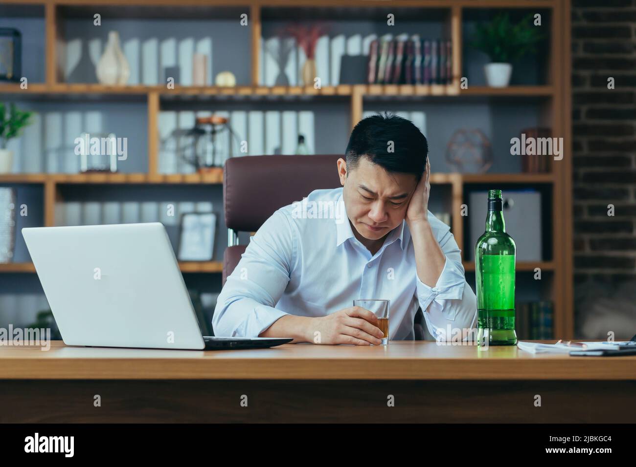 Asian businessman fails, man in despair drinks hard liquor, sitting ...