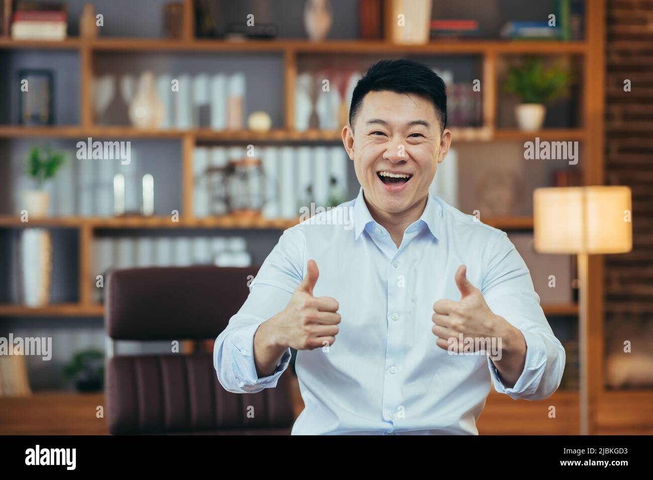 Successful asian man in shirt working late in classic office, portrait ...
