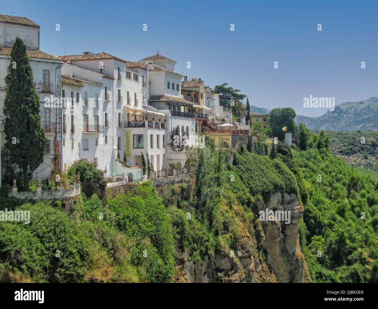 Restaurants and houses on a cliff in the historical town of Ronda in ...