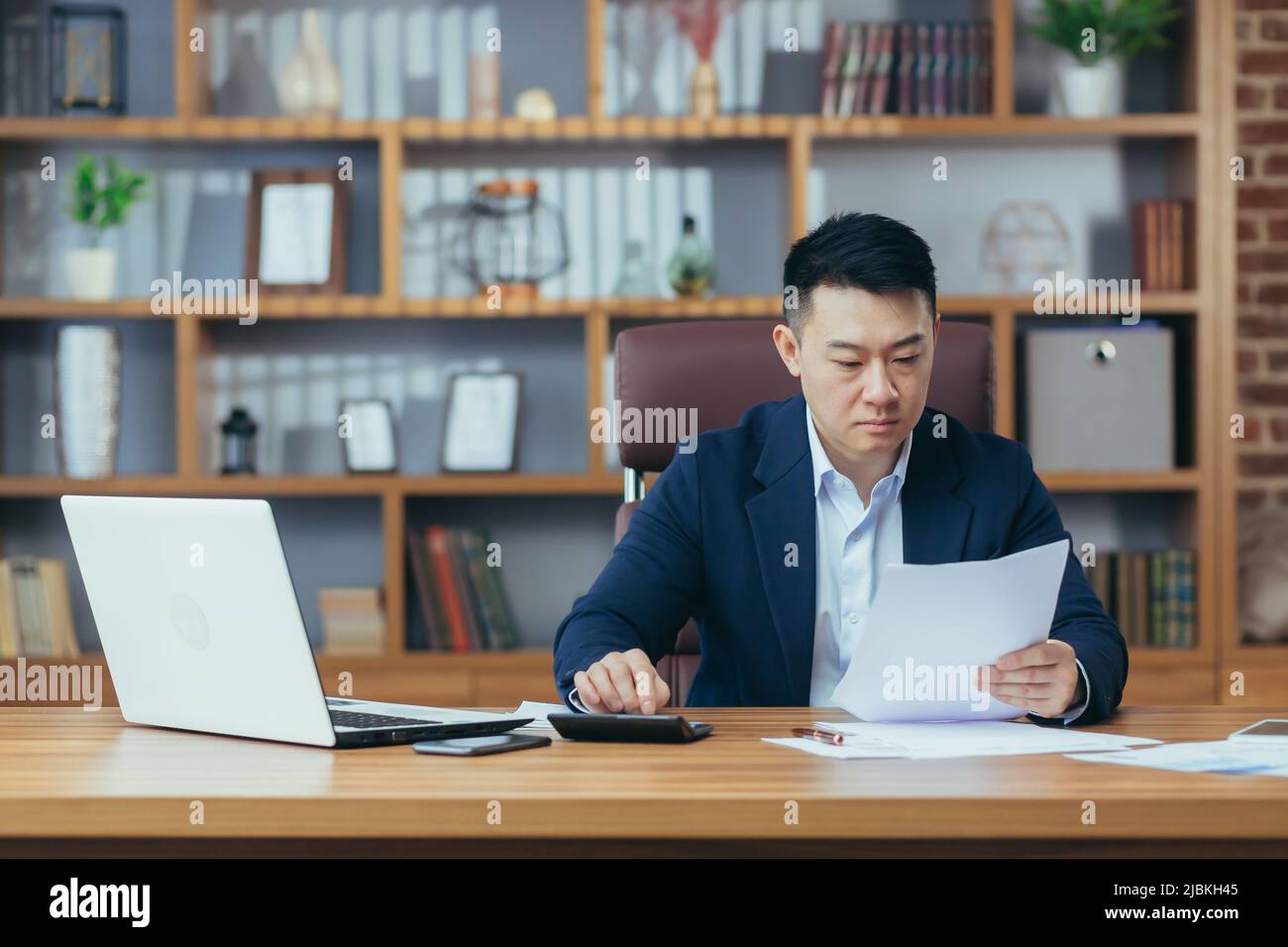 Accountant-auditor works in a classic office, calculates financial ...