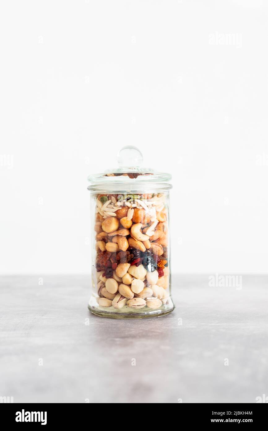 glass jar of mixed nuts including almonds cashews and pistachios ...
