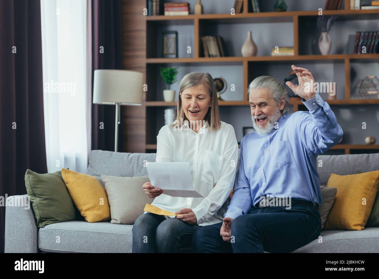 Senior gray haired family member receiving letter or document rejoicing ...