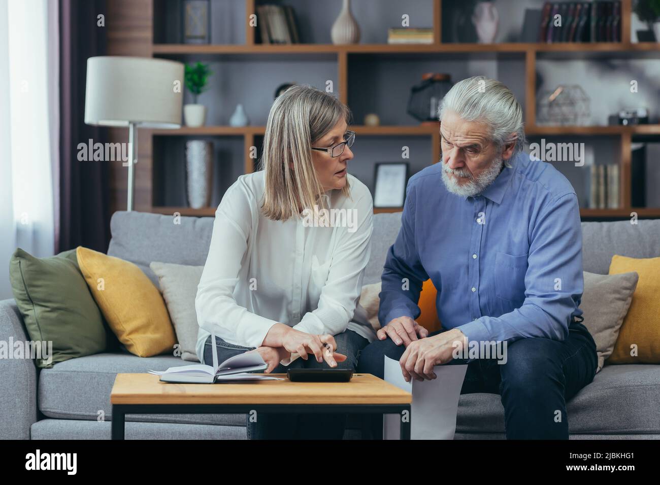 gray hair mature senior couple counting money and calculating finances ...
