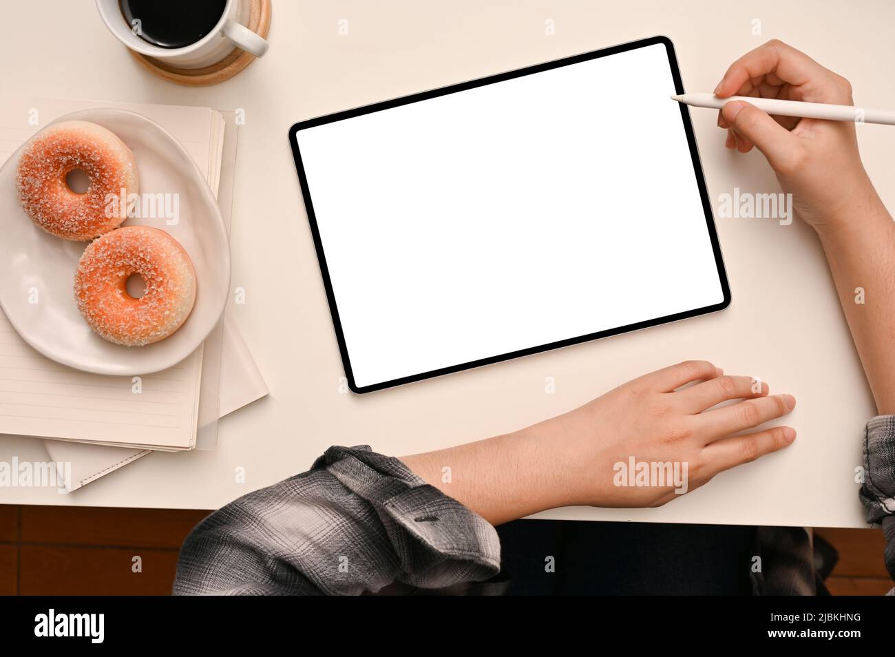 Overhead view, A woman hands using stylus pen write on a digital tablet ...
