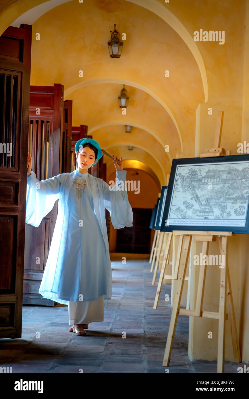Ancient Museum, Hue City, Vietnam - April 27, 2022: Model wears a ... Ancient Museum, Hue City, Vietnam - April 27, 2022: Model wears a ...