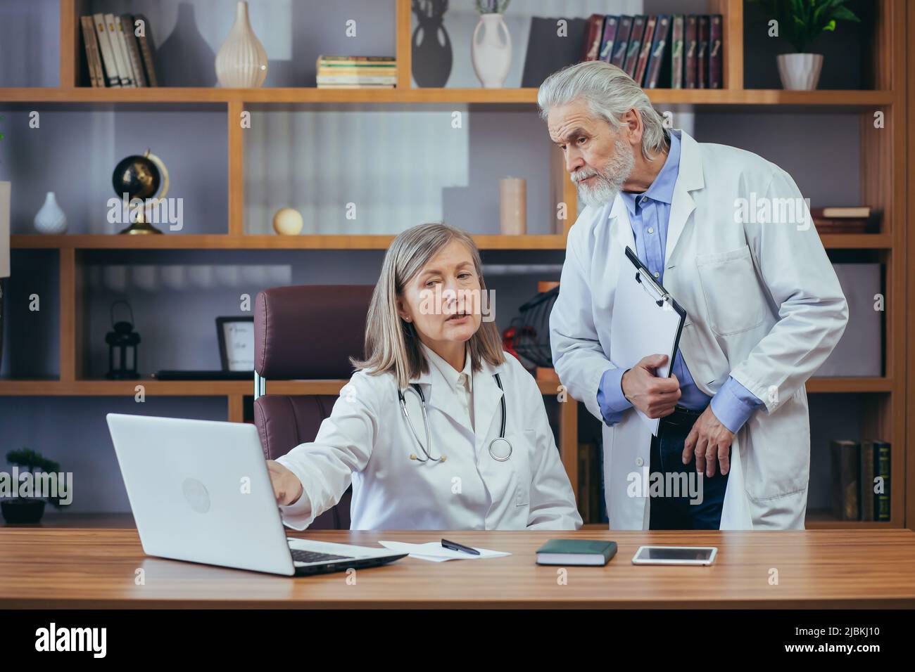 Senior doctors consult and practice in the classic office of the clinic ...