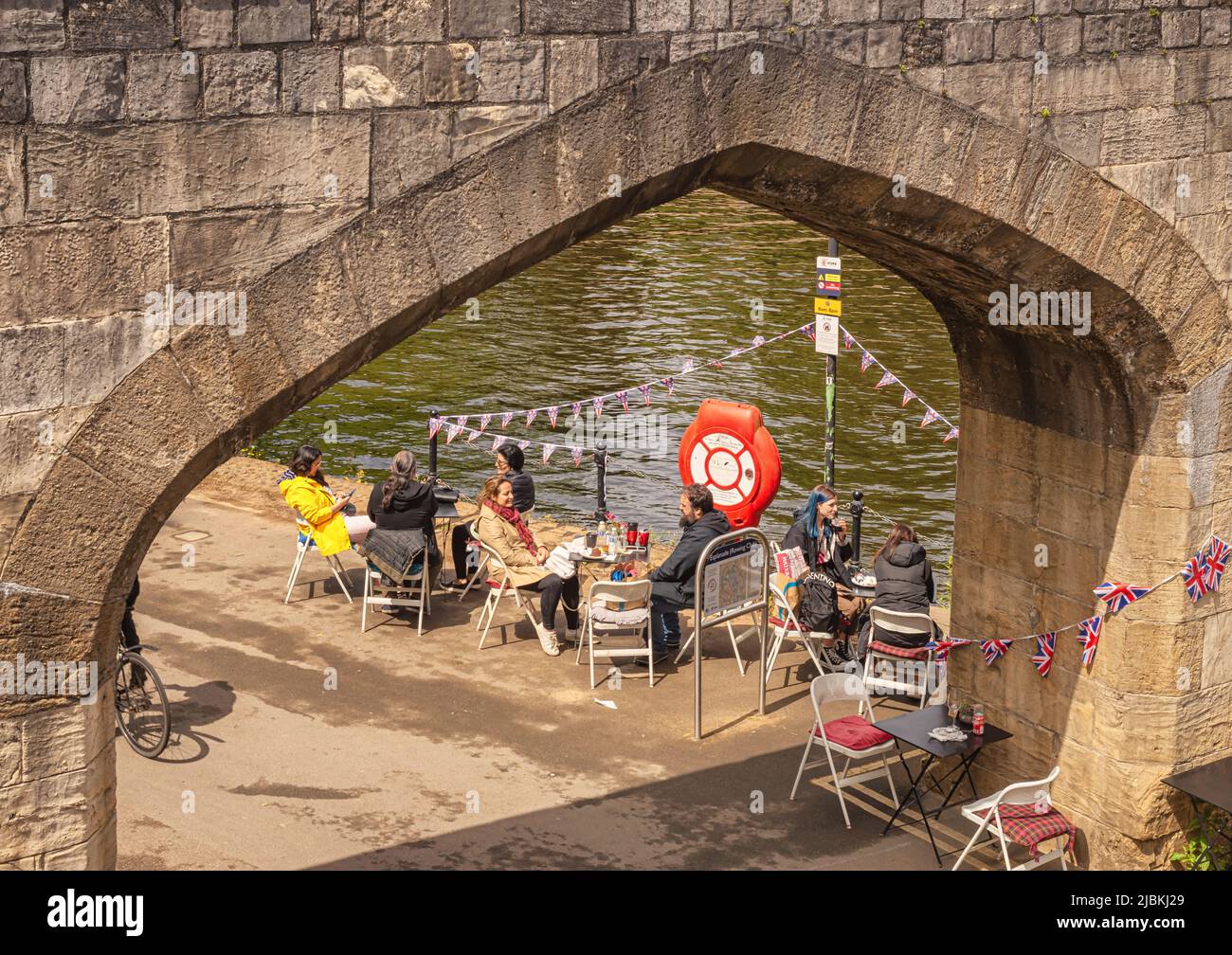 Person sitting beside bridge hi-res stock photography and images - Alamy
