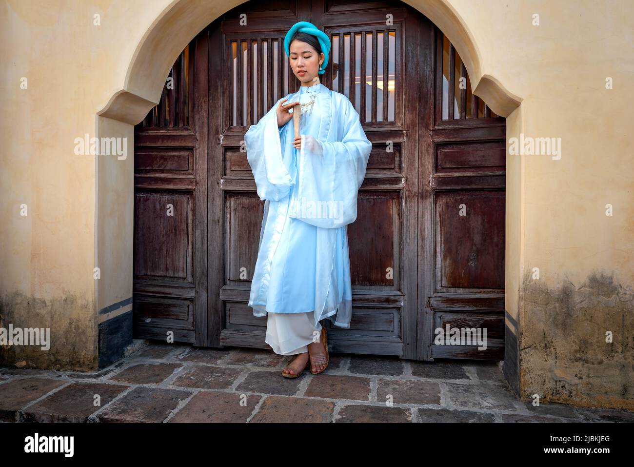 Ancient Museum, Hue City, Vietnam - April 27, 2022: Model wears a ... Ancient Museum, Hue City, Vietnam - April 27, 2022: Model wears a ...