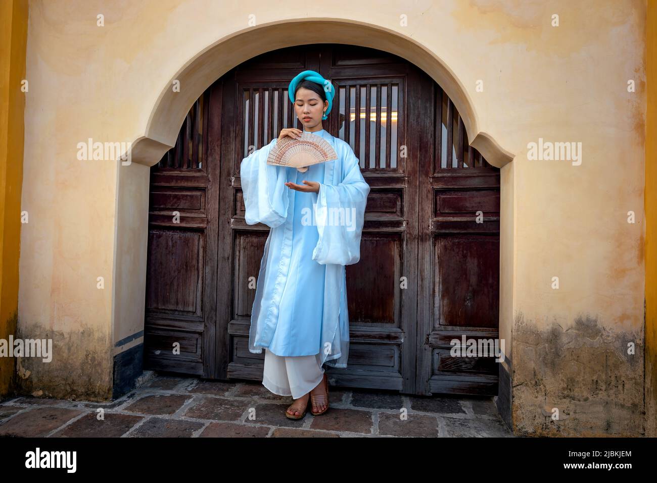 Ancient Museum, Hue City, Vietnam - April 27, 2022: Model wears a ... Ancient Museum, Hue City, Vietnam - April 27, 2022: Model wears a ...